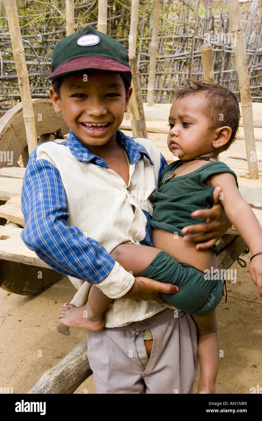 Indian boy with baby, India, Madhya Pradesh, Tala/Bandhavgarh NP, Mai ...