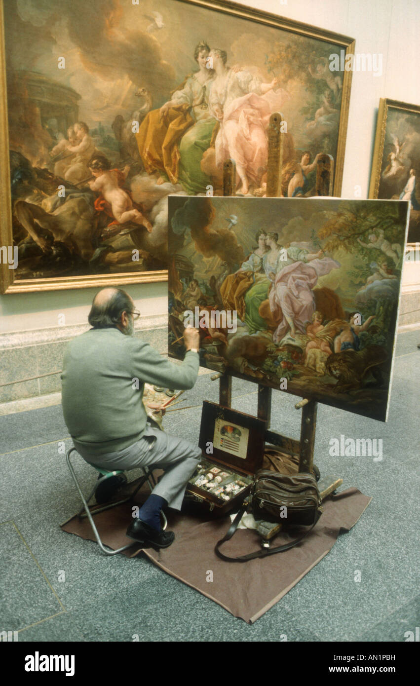 Painter working at easel with paints, making copy of old painting in ...