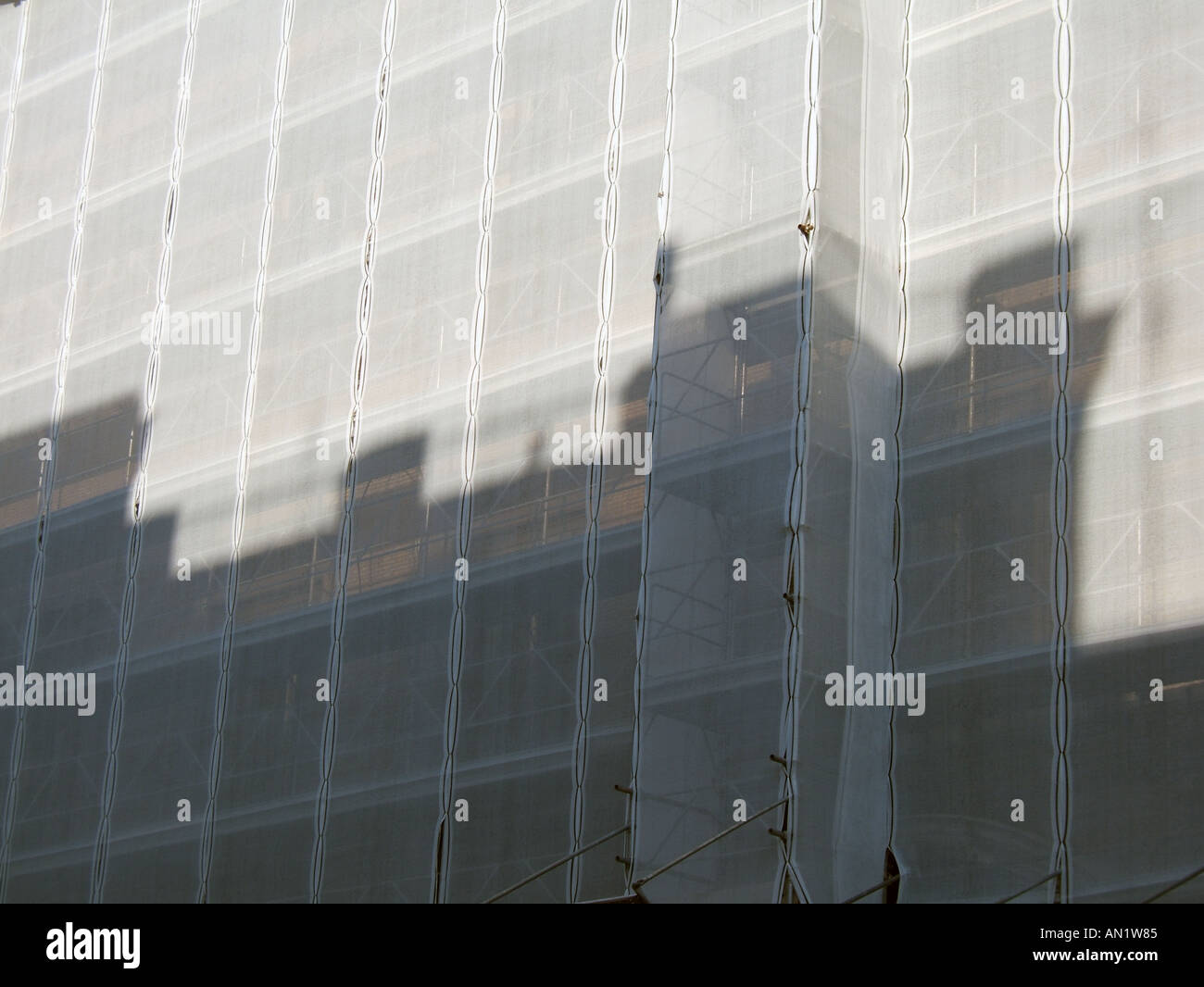 scaffolding on building with protective mesh Stock Photo - Alamy