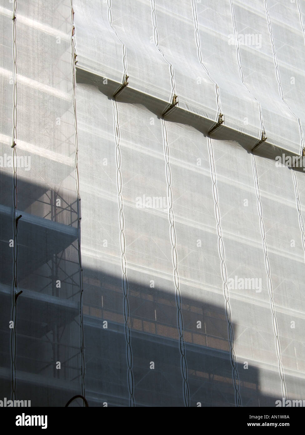 scaffolding on building with protective mesh Stock Photo - Alamy
