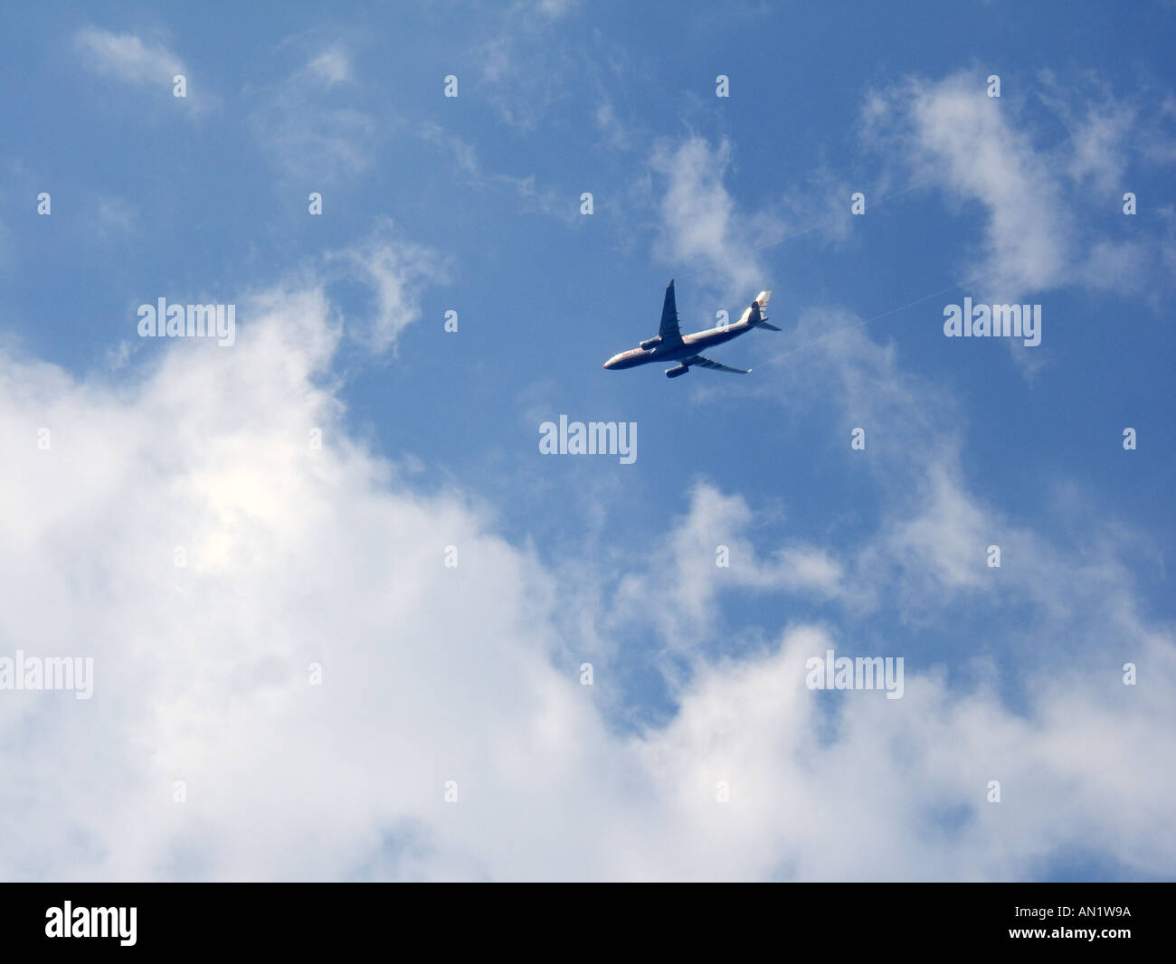 plane moving across sky with clouds Stock Photo - Alamy