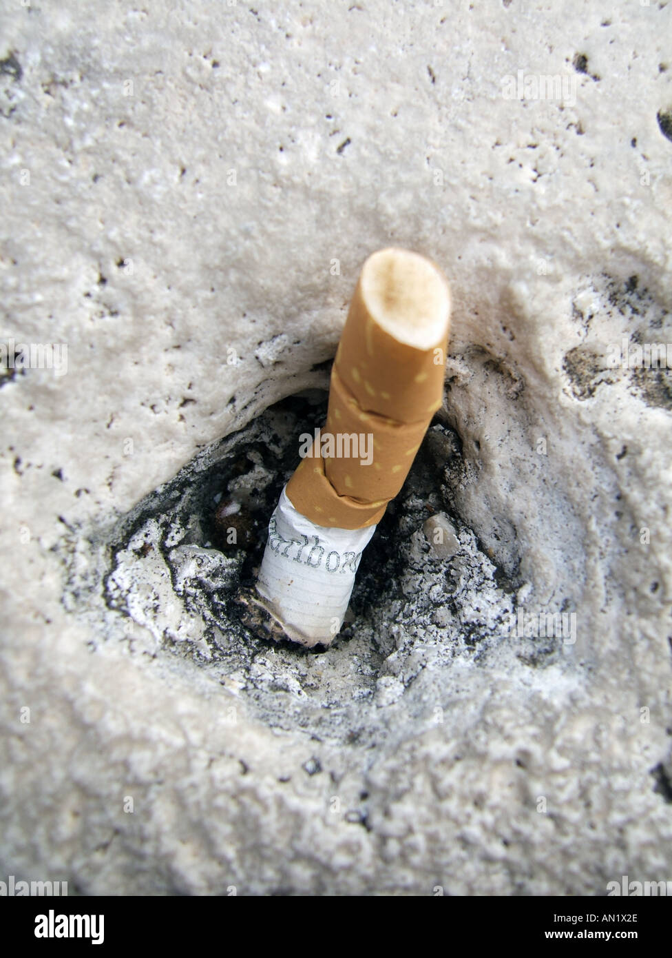 cigarette stub in hole in wall Stock Photo - Alamy