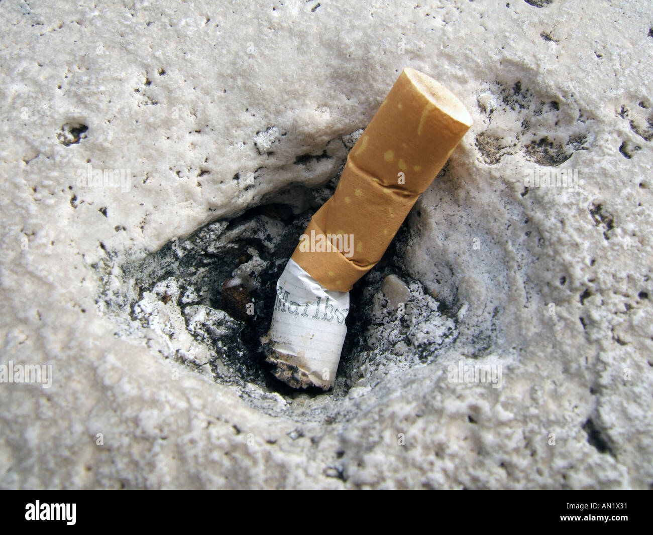 cigarette stub in hole in wall Stock Photo - Alamy
