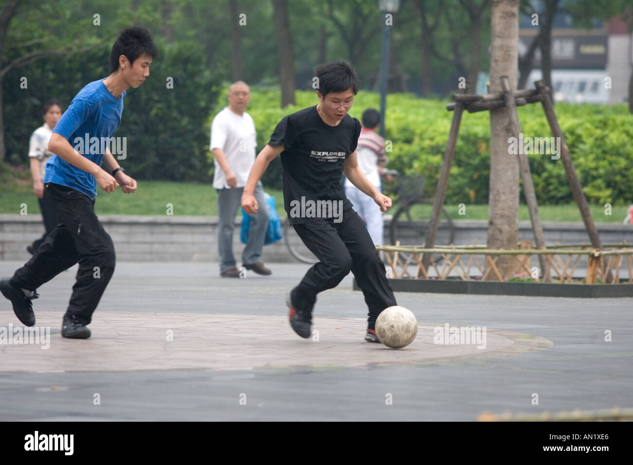 Chinese youth playing football in the street Shanghai China Stock Photo ...