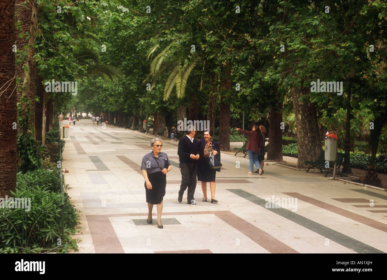 Paseo del Parque, Malaga, with people walking past trees Stock Photo ...
