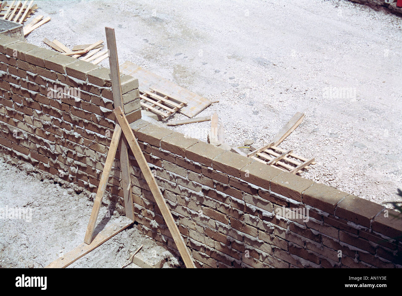 red brick wall under construction Stock Photo - Alamy