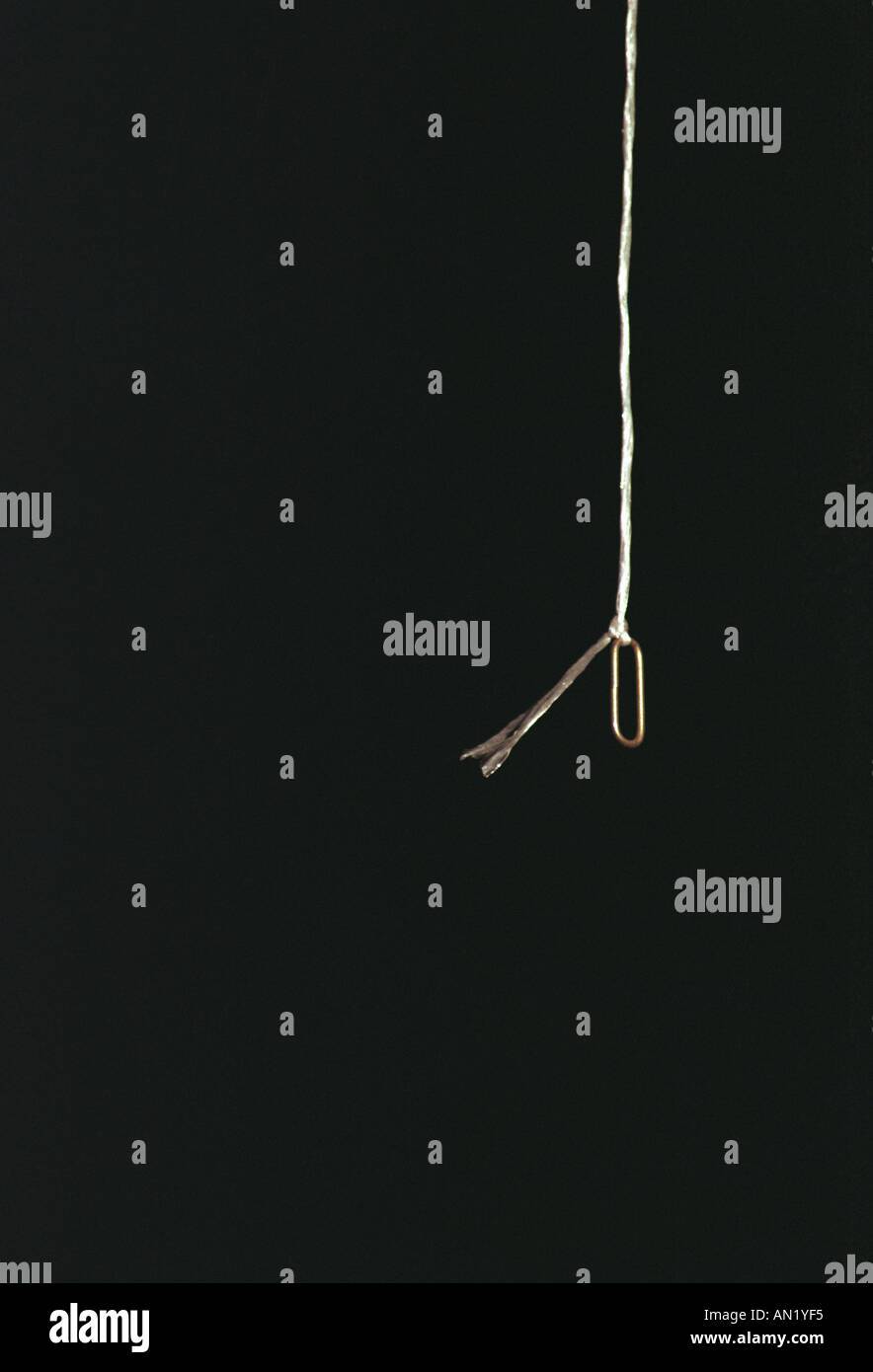 one paperclip tied to piece of string Stock Photo - Alamy