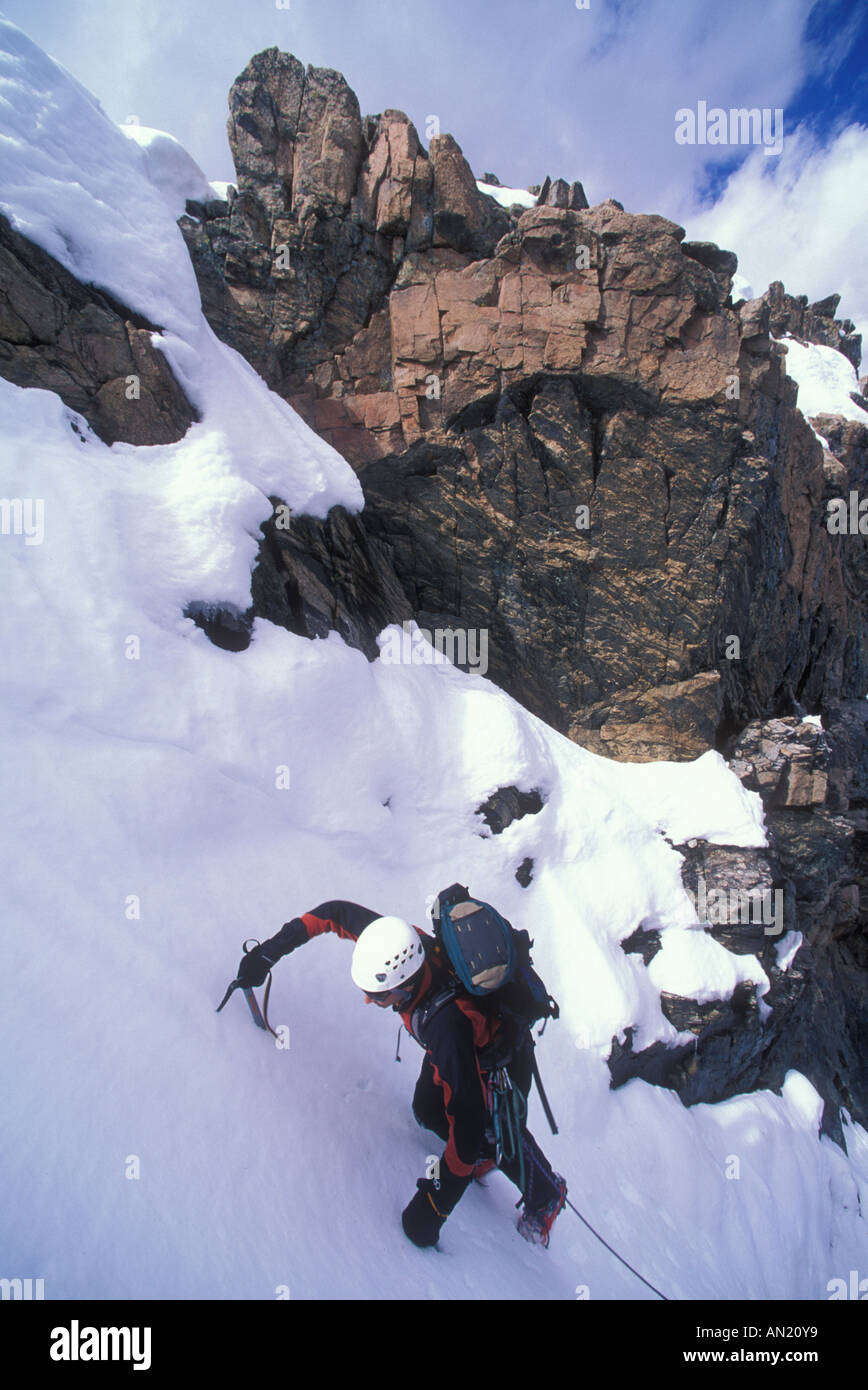 Alpine climber ascending a steep snow chute Stock Photo - Alamy