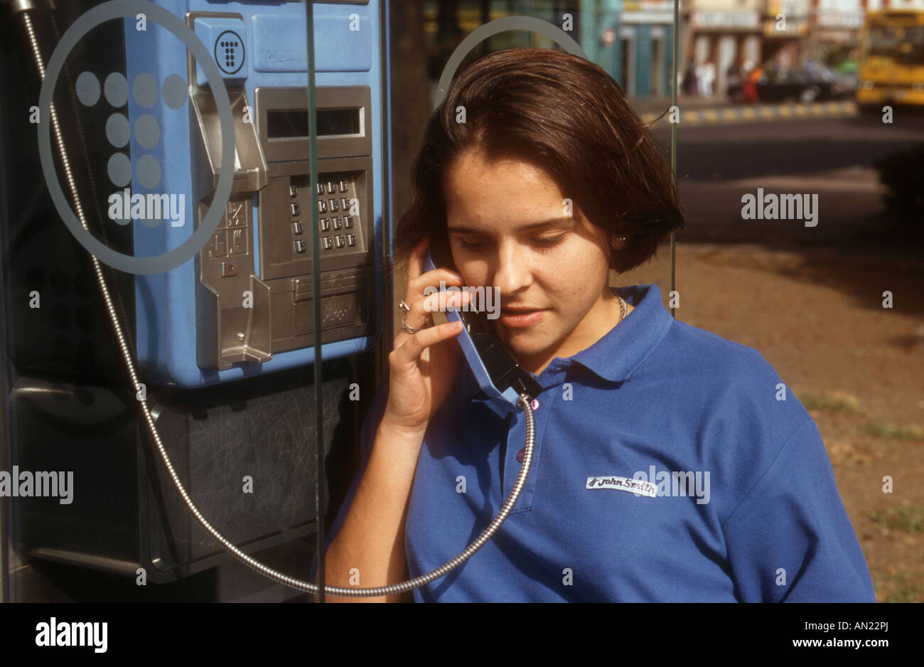 Young girl using public telephone. Spain Stock Photo - Alamy
