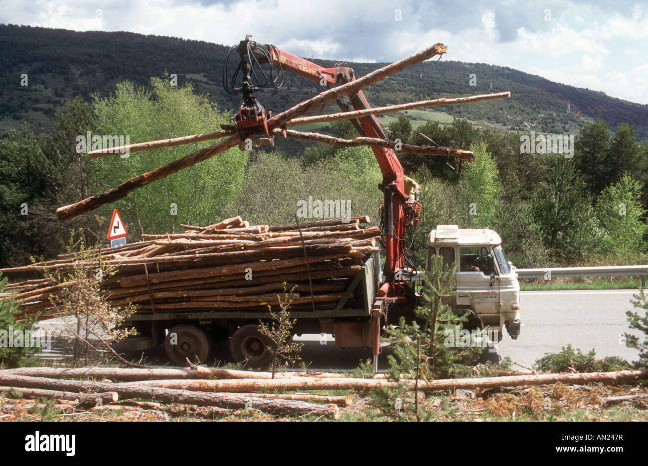 Loading logs onto lorry in the Pyrenees Stock Photo - Alamy
