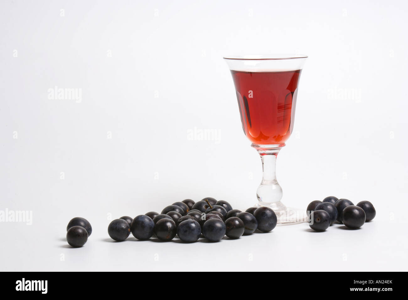 Sloe gin in a Victorian liqueur glass on a white background Stock Photo ...