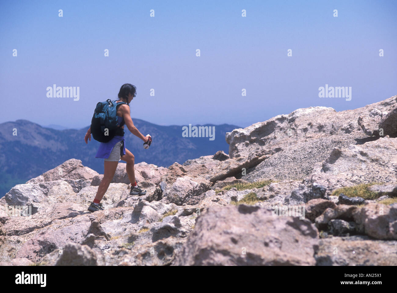 Woman hiking uphill Stock Photo - Alamy