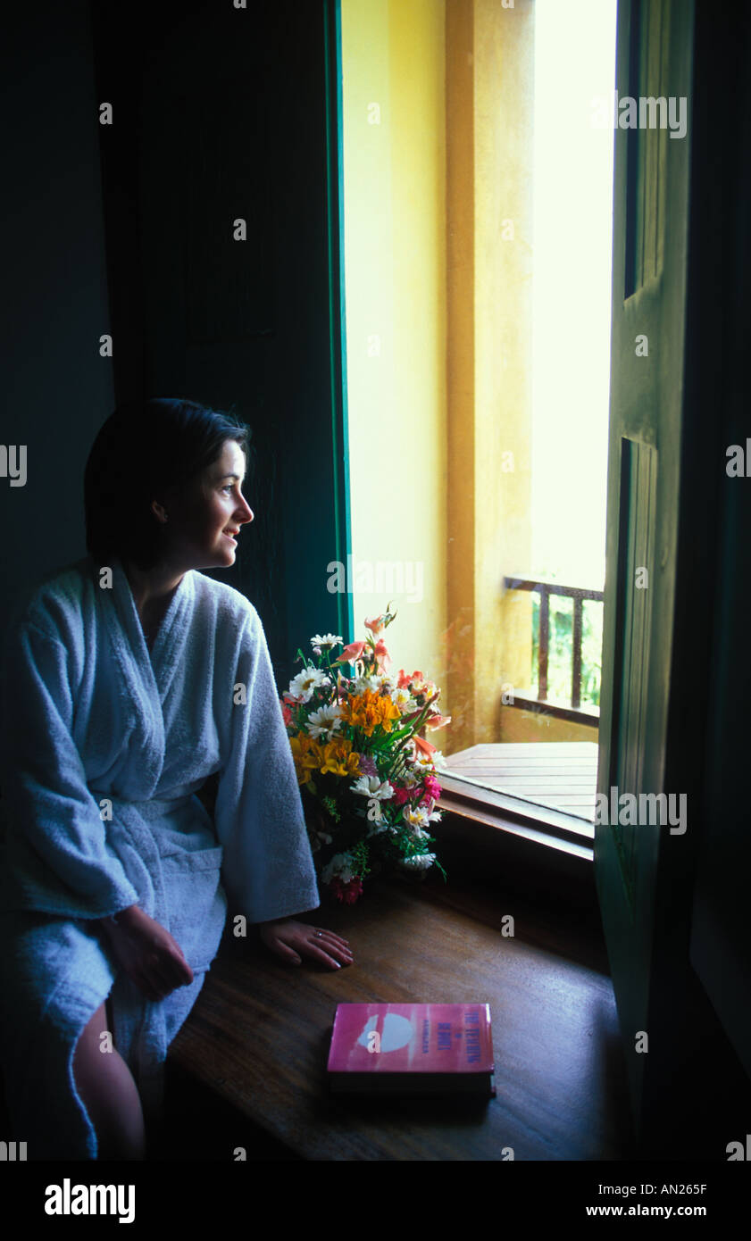 Relishing a moment of tranquility in her luxury hotel room, a young ...