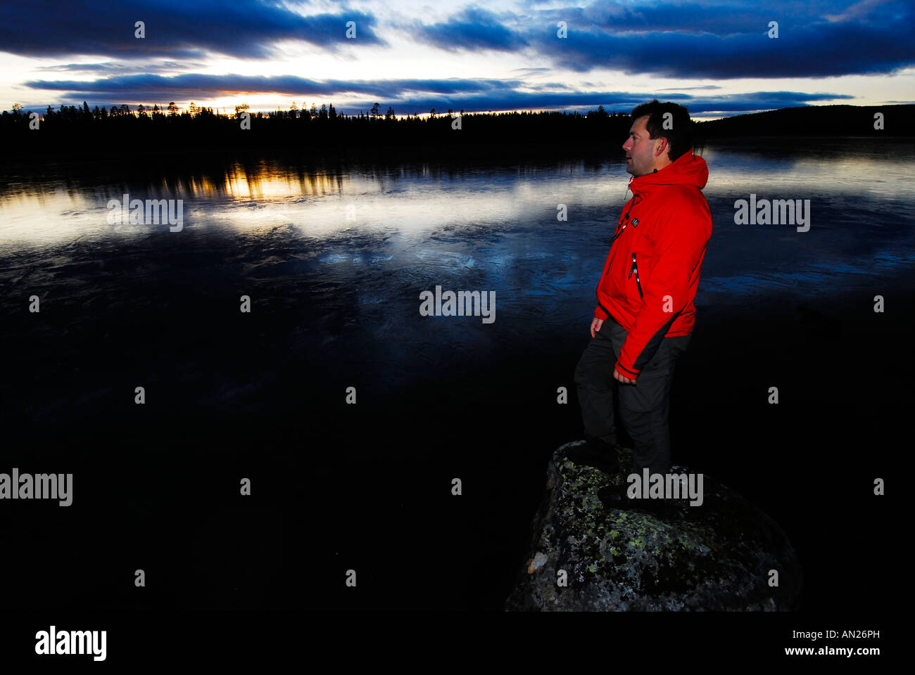 Man looking over iced Lake Ice Structures at evening light sweden ...