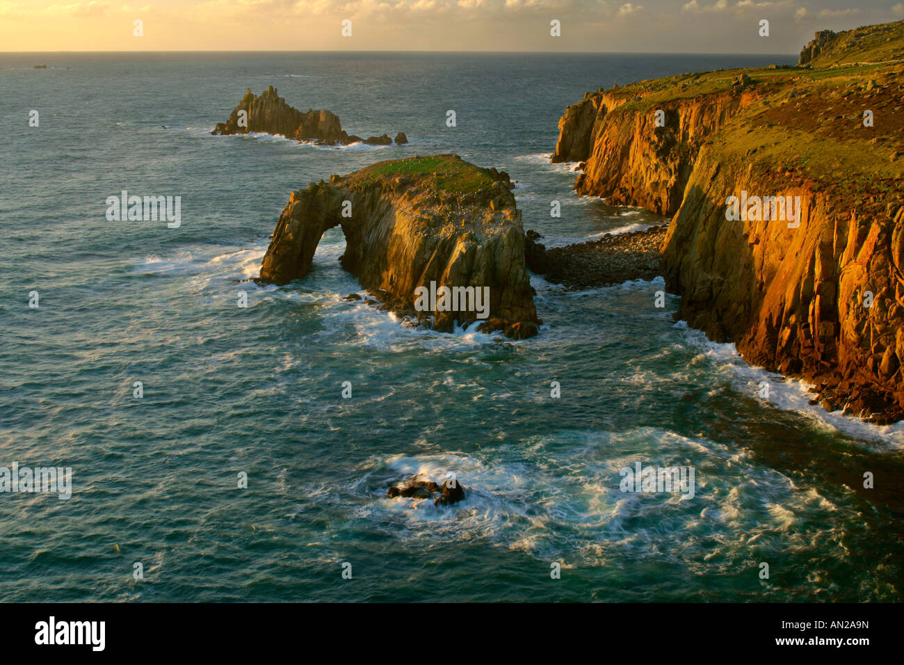 rugged coastline with rock arch in last evening light Lands End ...