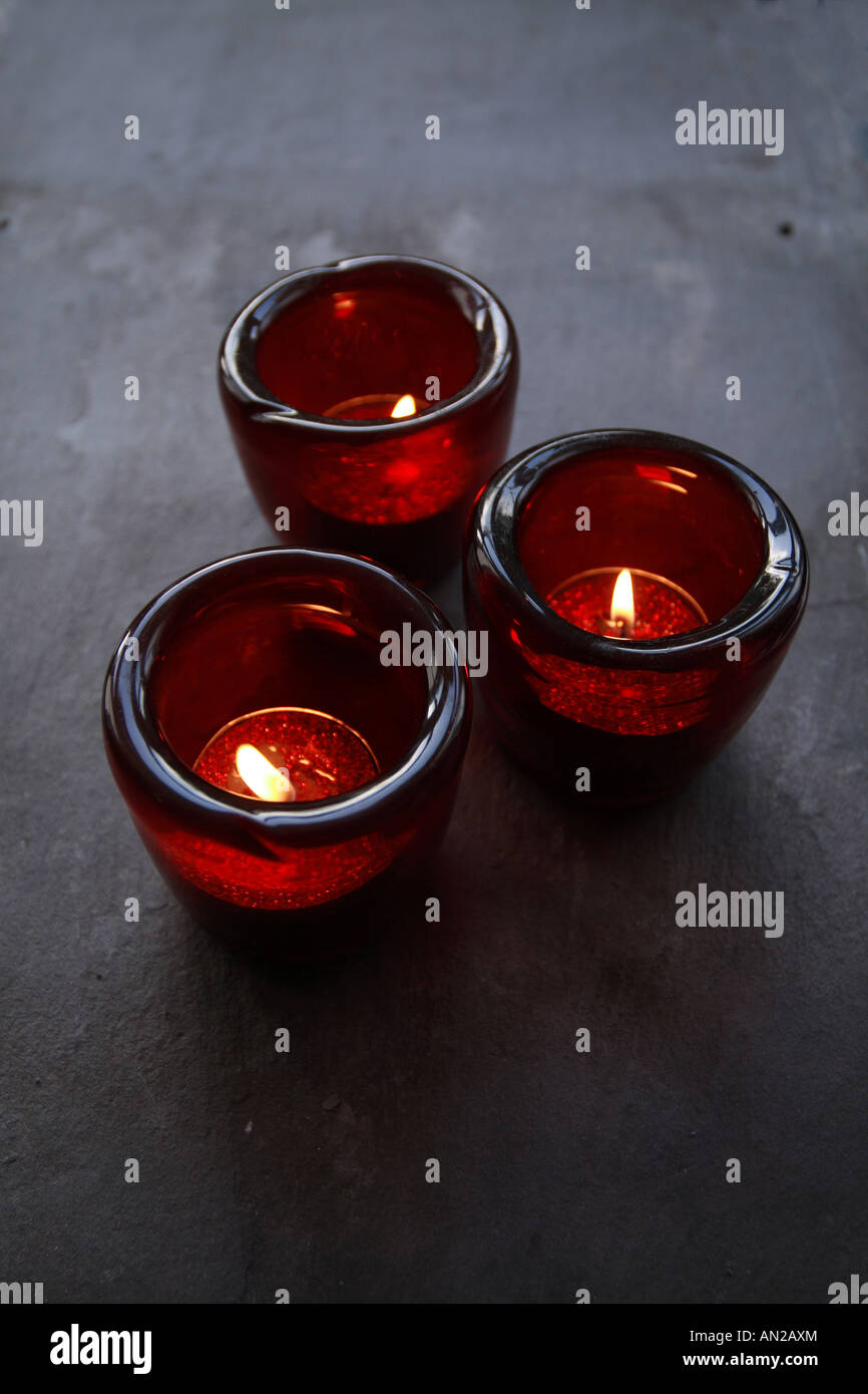 a group of red glass candle holders with glitter candles Stock Photo ...