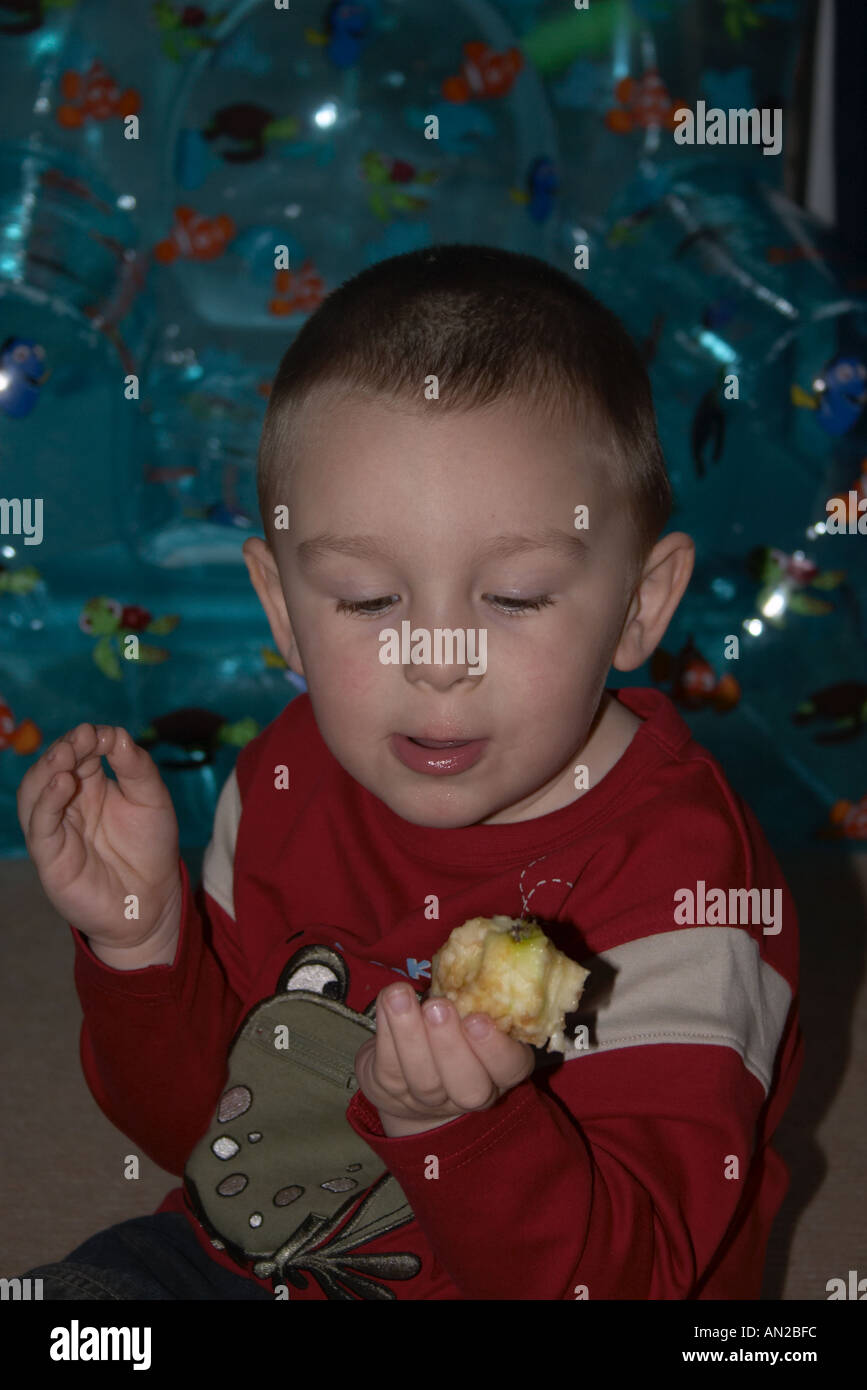 Youngster eating fruit Stock Photo - Alamy