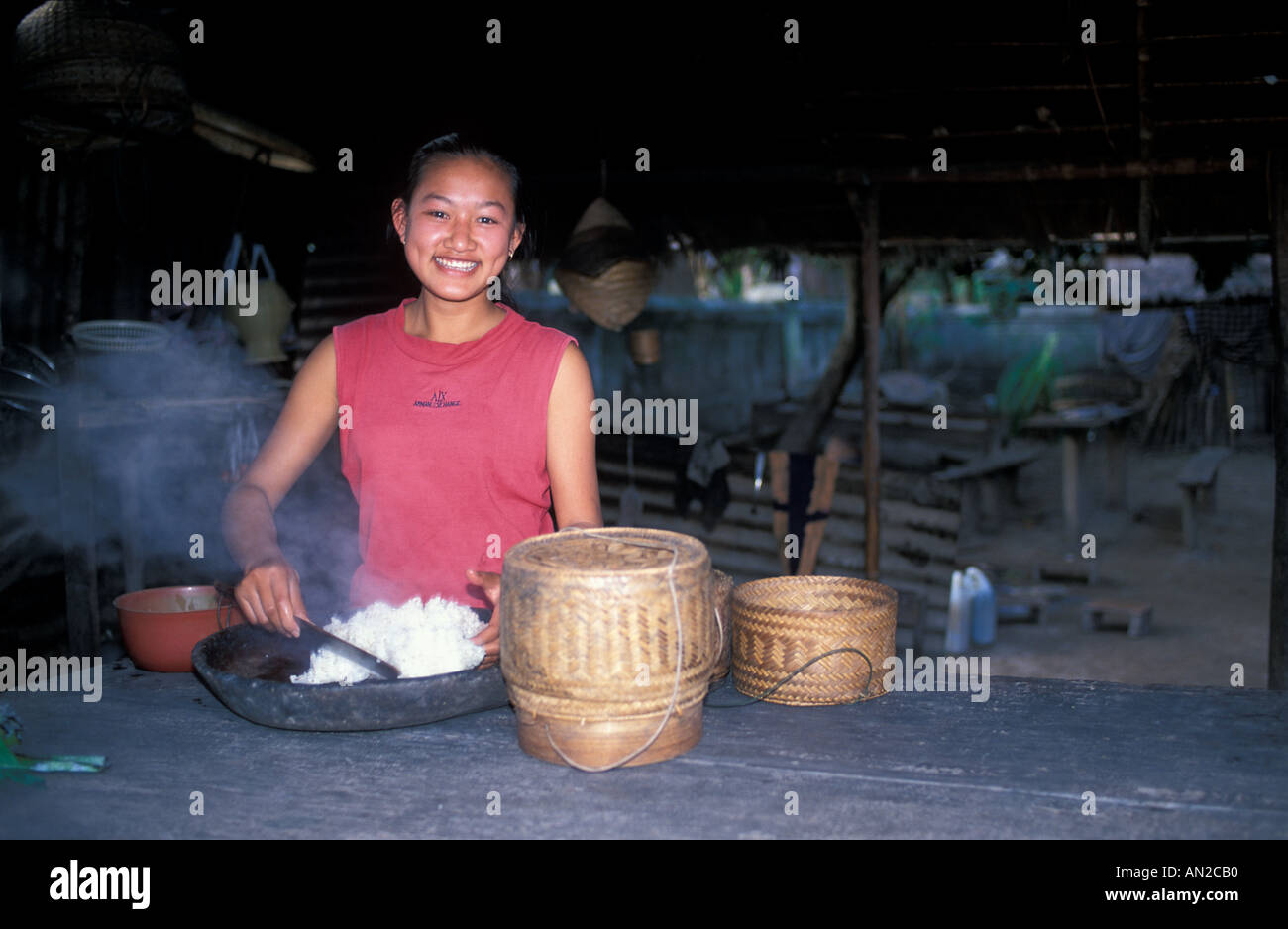 friendly woman at a local eatery selling sticky rice Village on the ...