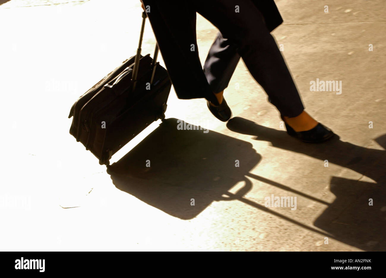 Woman Pulling Wheeled Suitcase Stock Photo - Alamy