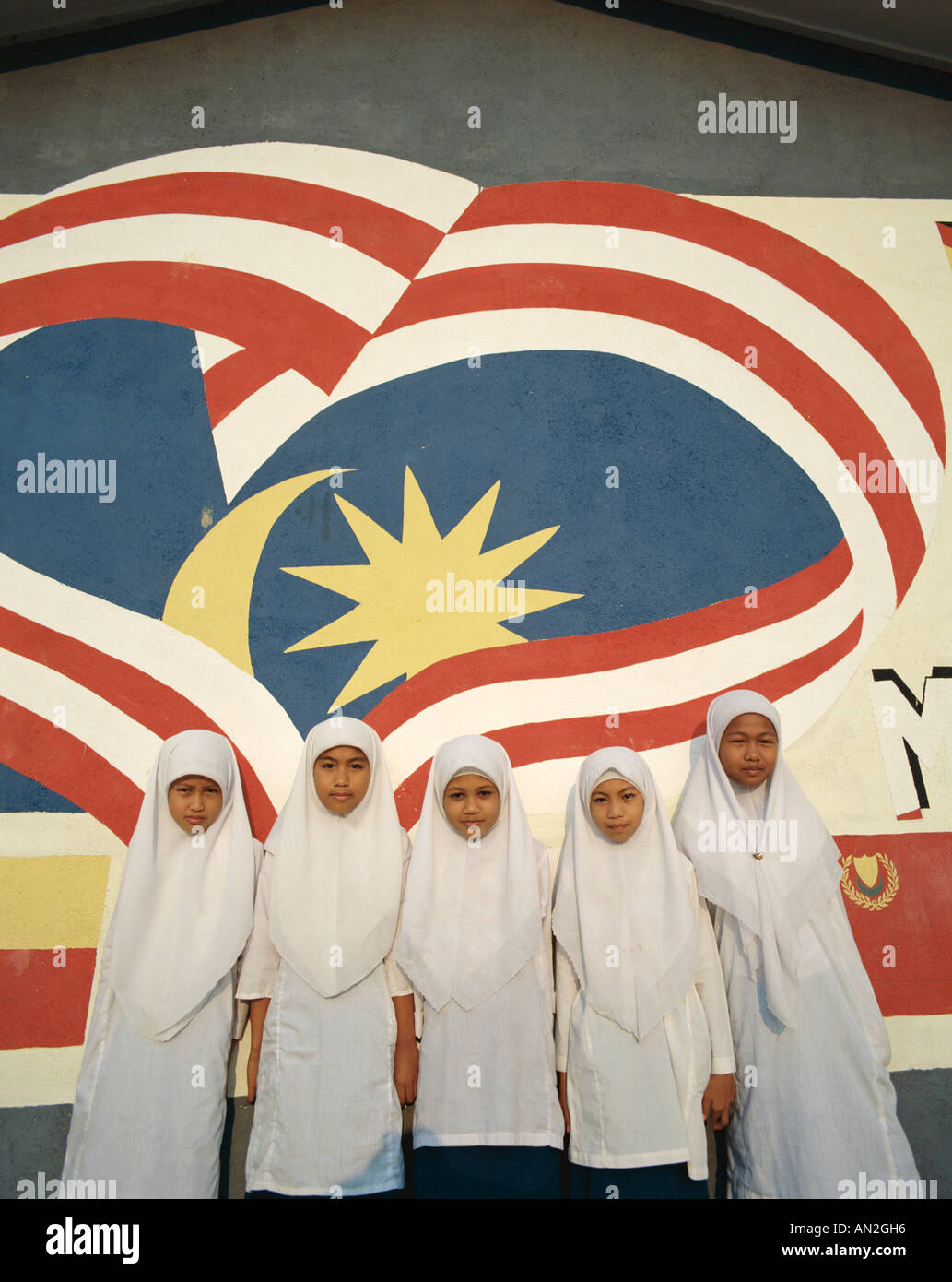 Muslim school girls in front of malaysian flag mural hi-res stock ...
