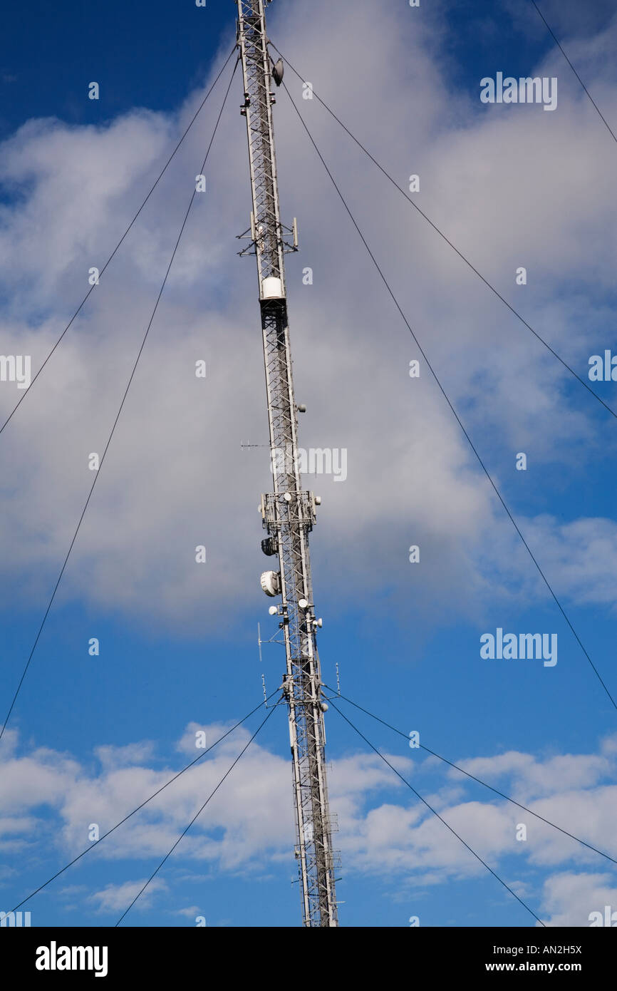 Transmitter mast viewed against a blue sky with some cloud Stock Photo ...