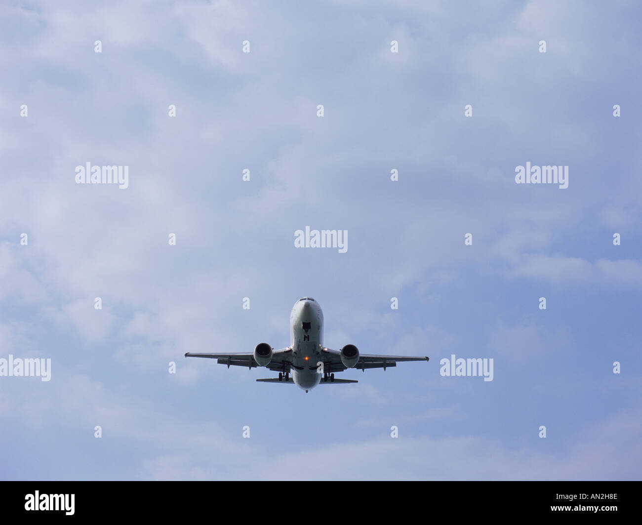 Passenger airplane flying low angle view Stock Photo - Alamy