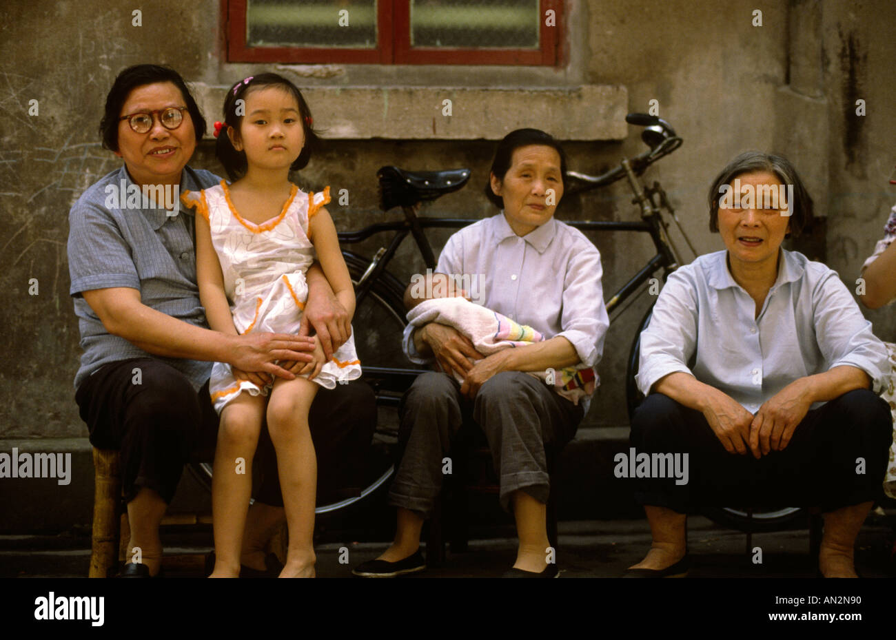 Three generations relax outside their home in Bejing China Stock Photo ...