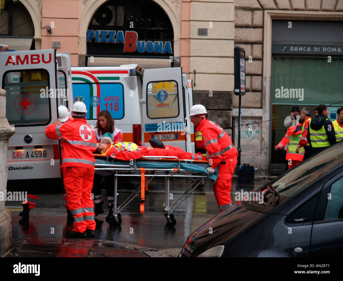 ambulance crew loading injured person onto ambulance during exercise to ...