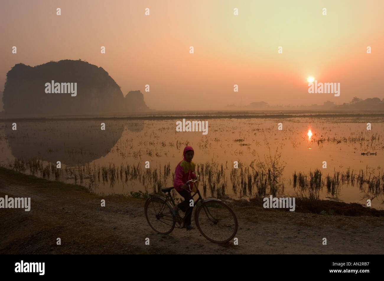 bicycle morning mist sunrise limestone mountain scenery Tam Coc Ninh ...