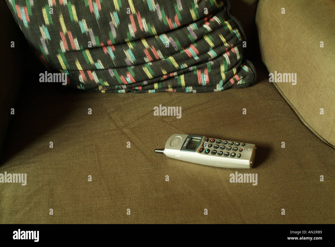 Cordless phone left on an armchair Stock Photo - Alamy