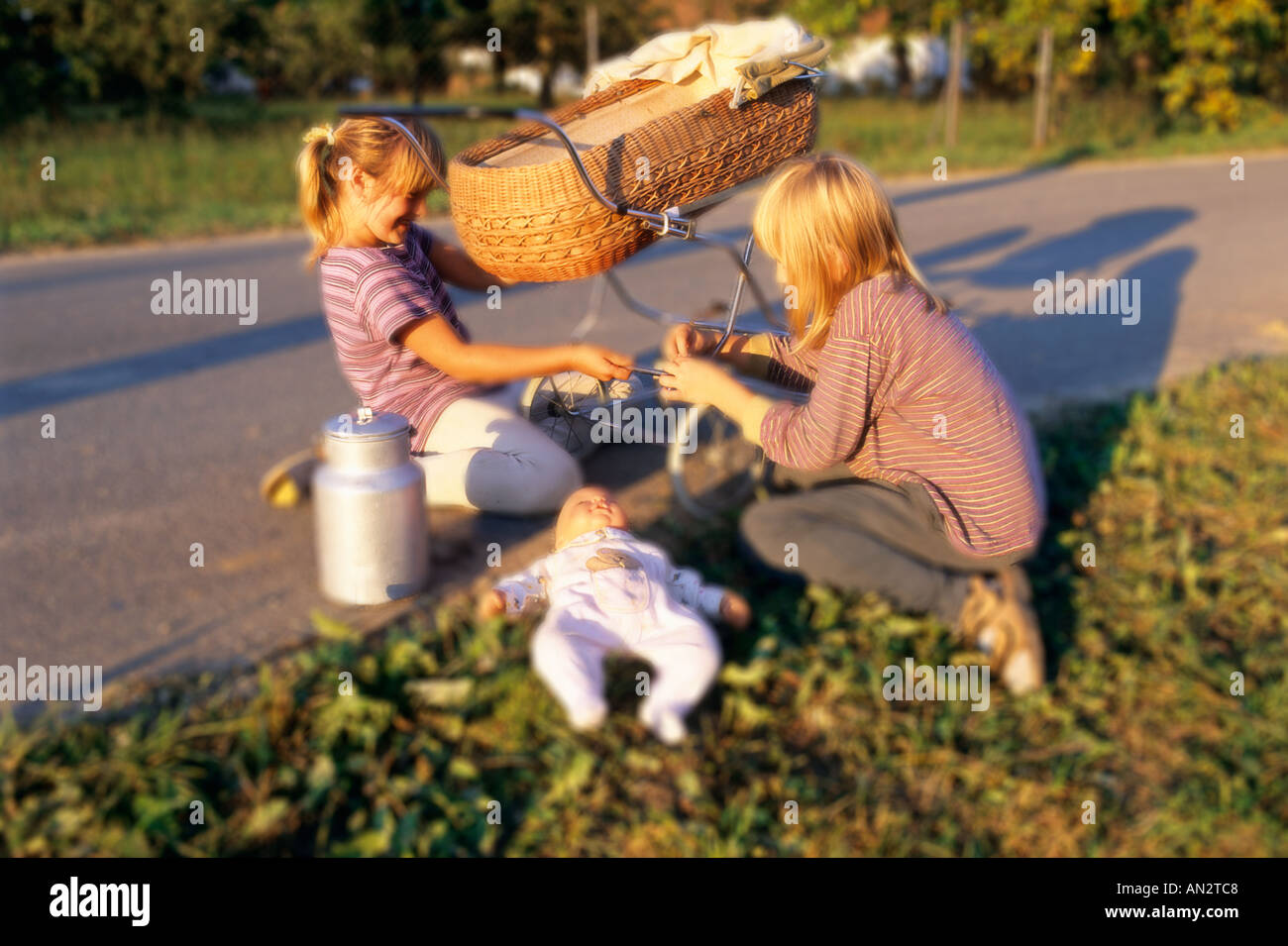 TWO GIRLS PLAYING WITH BABY CARRIAGE Stock Photo - Alamy