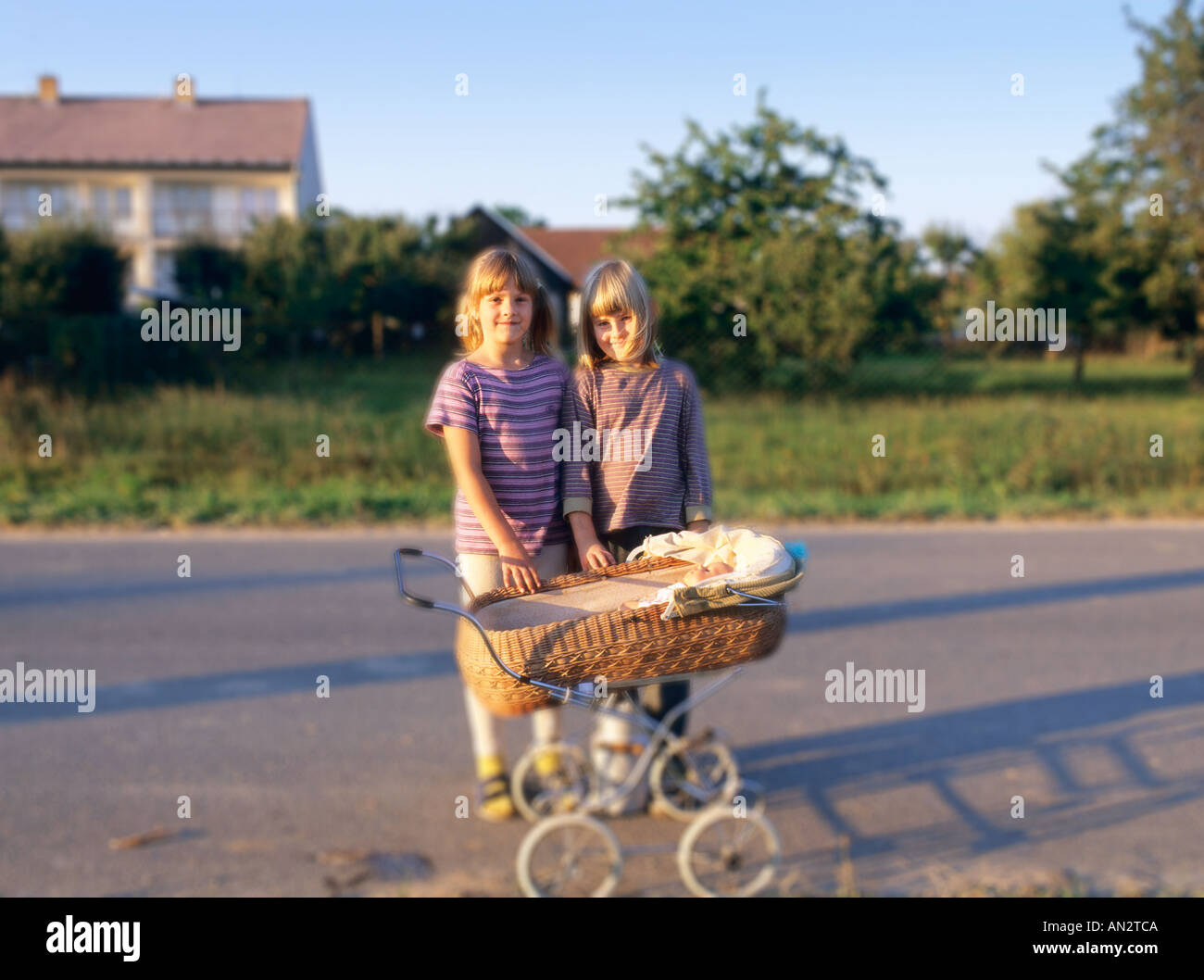 TWO GIRLS PLAYING WITH BABY CARRIAGE Stock Photo - Alamy