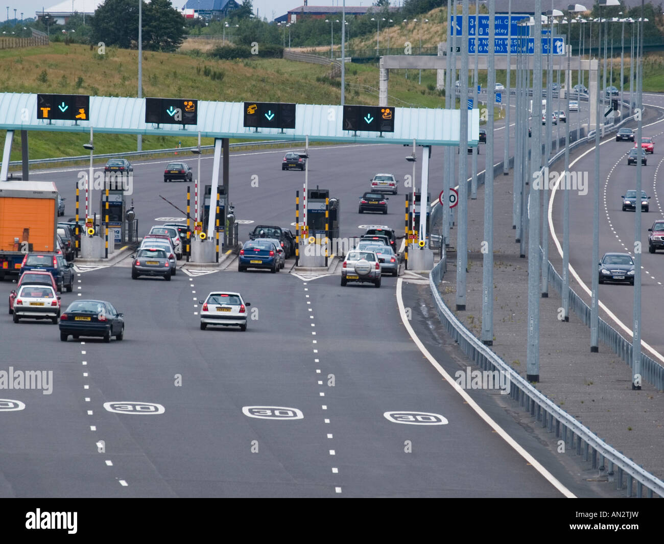 M6 TOLL MOTORWAY ROAD from above with cars approaching toll booths West ...