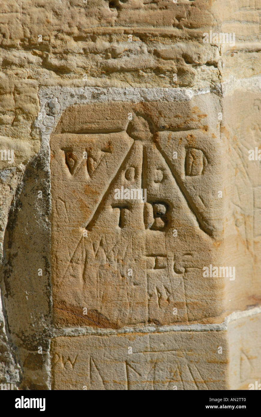 A roughly carved Ordnance bench mark sign carved into the soft ...