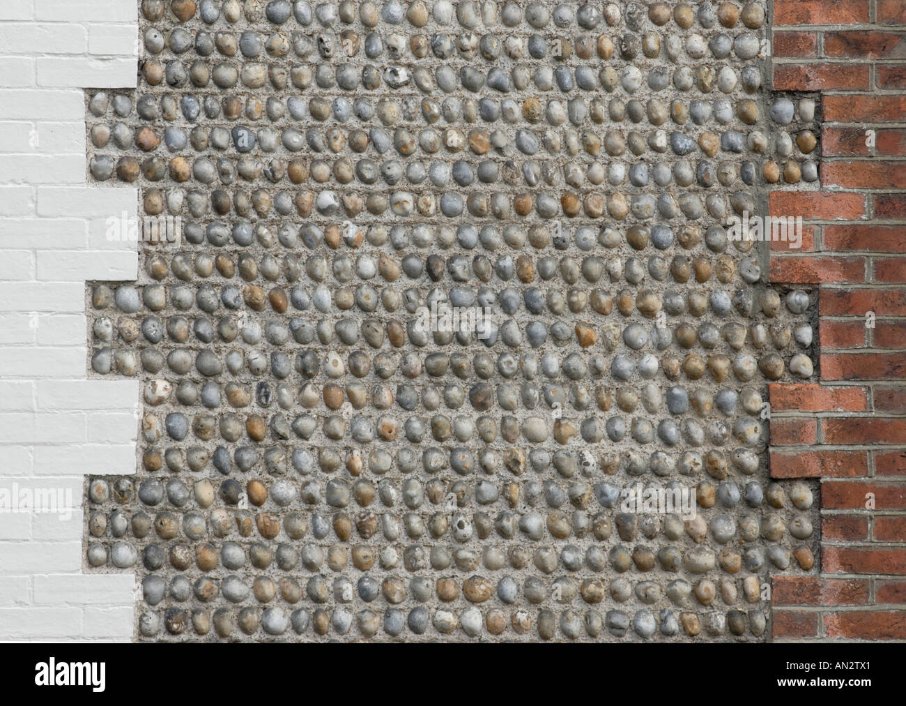 Sea polished beach cobbles used as a building material in a house wall ...