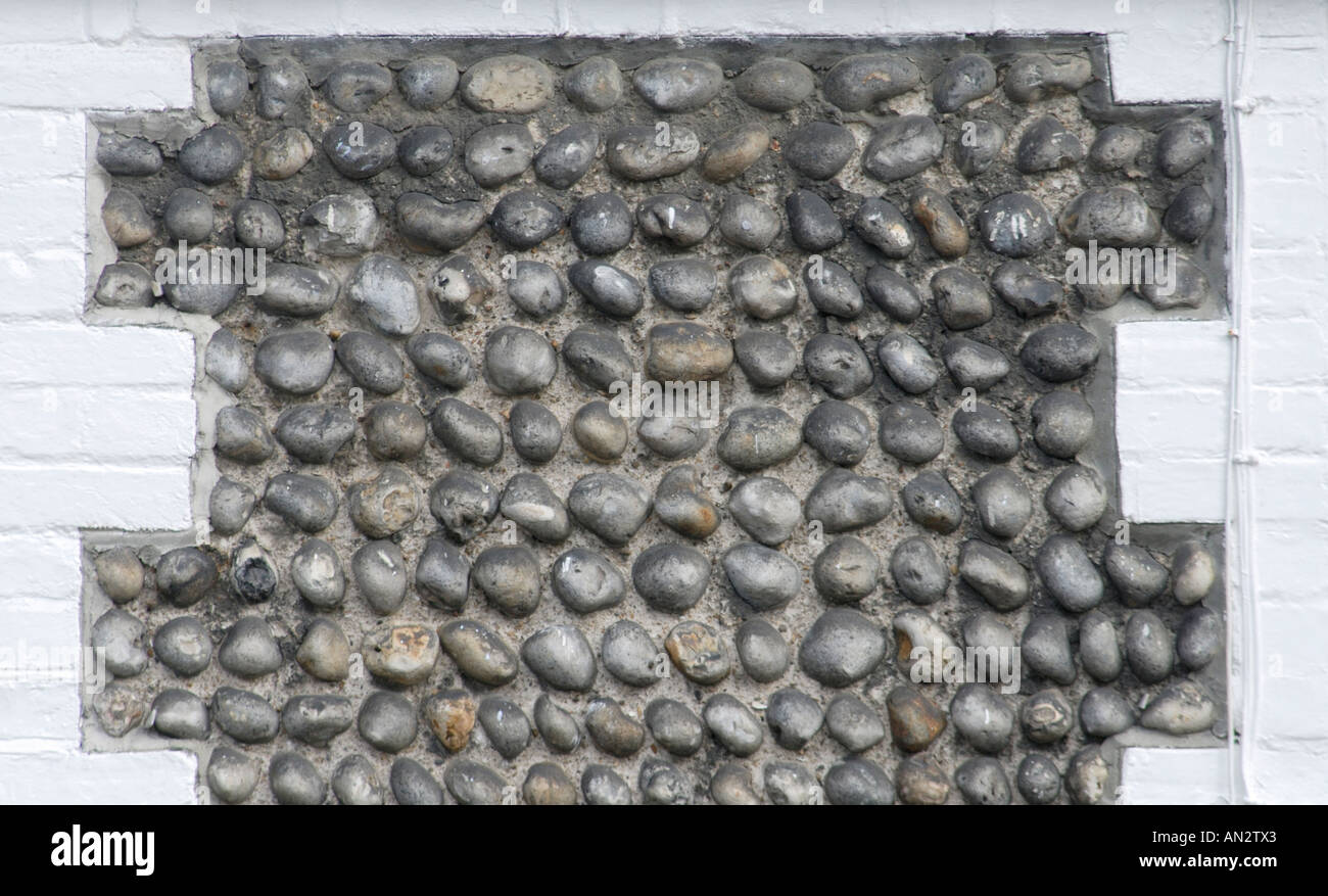 Sea polished beach cobbles used as a building material in a house wall ...