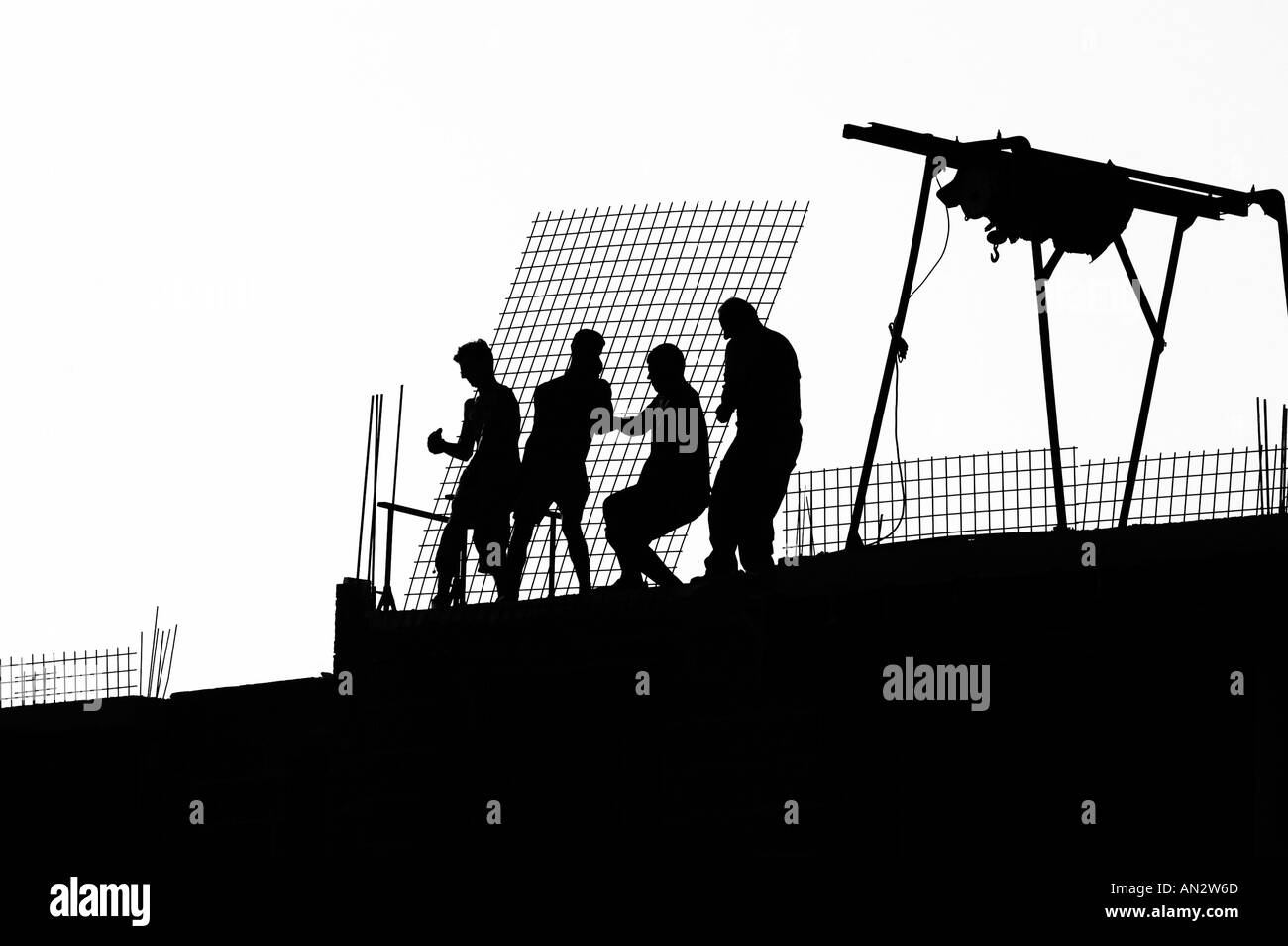 monochrome silhouette men at work building a house or hotel in a ...