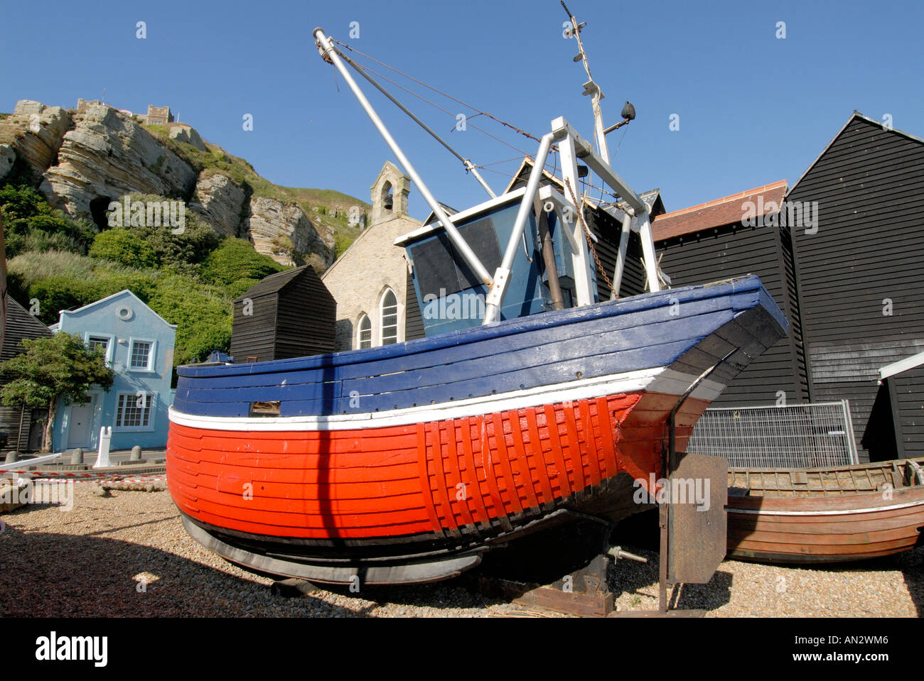 Preserved red white and blue clinker built fishing boat Stock Photo - Alamy