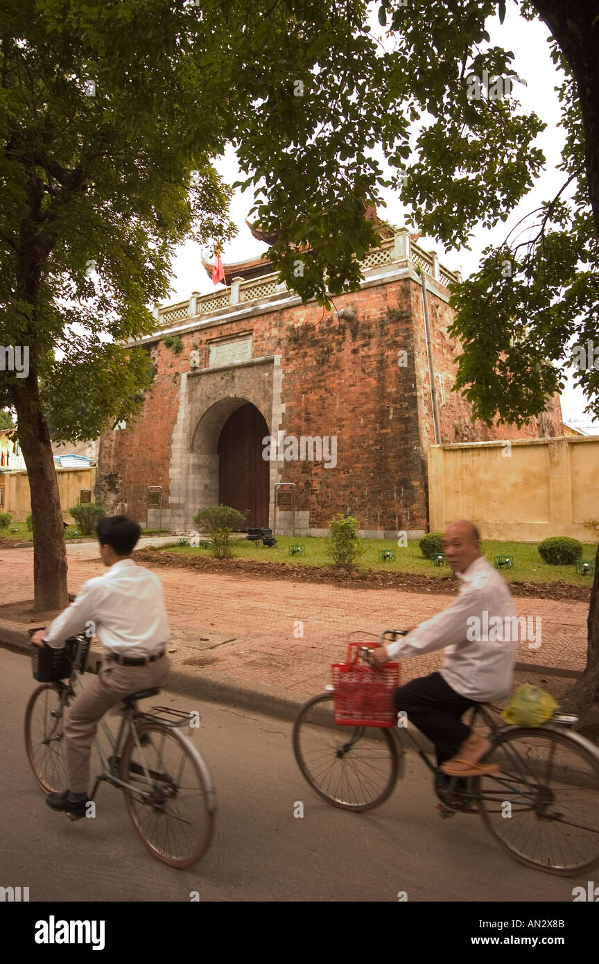 two men on bicycles outside walled city gate Hanoi Northern Vietnam ...