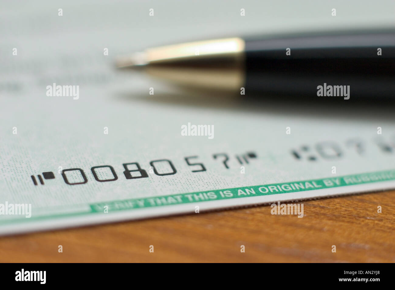 pen on cheque with close up of cheque number Stock Photo - Alamy