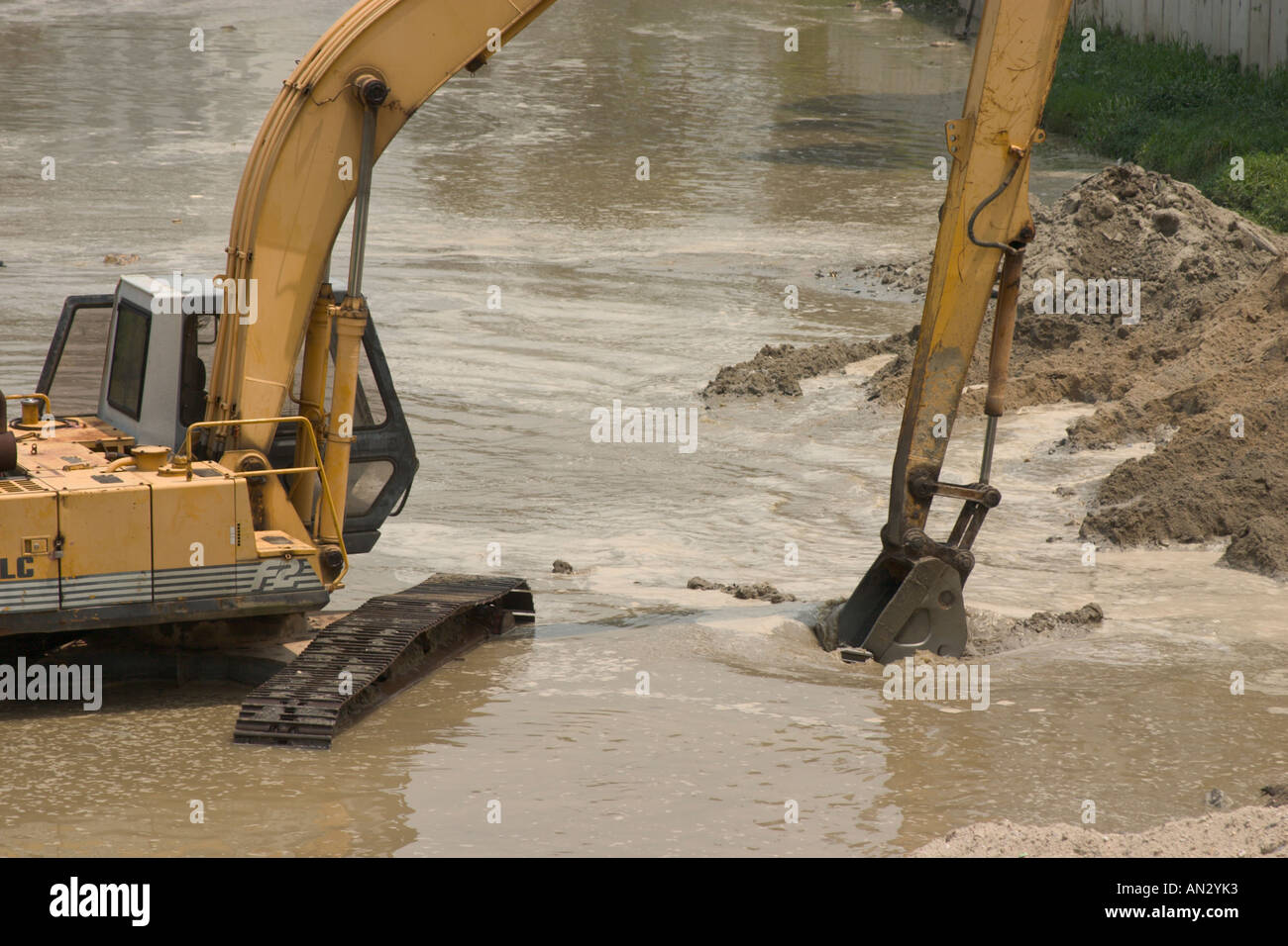 excavator clearing sand from a river Stock Photo - Alamy