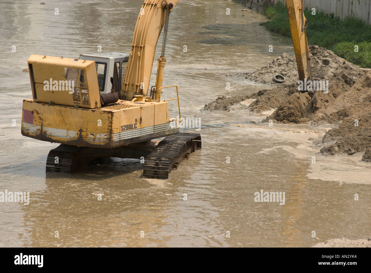 excavator clearing sand from a river Stock Photo - Alamy
