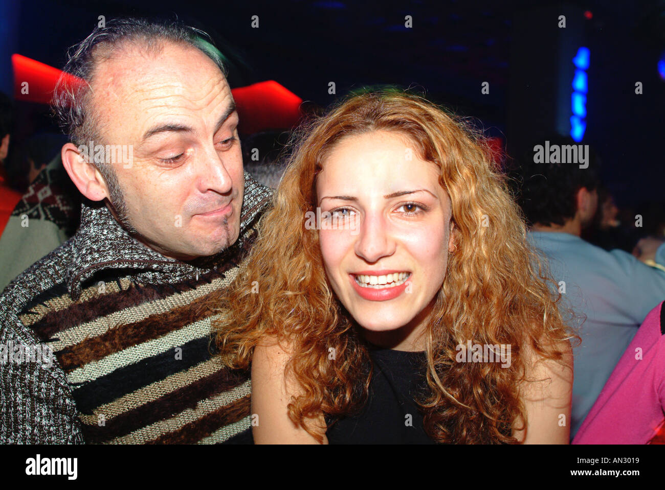 man chatting up young girl in a night club Stock Photo - Alamy