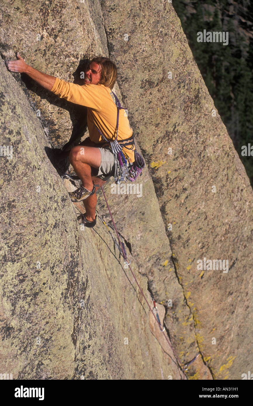Rock climber reaching for a handhold Stock Photo - Alamy