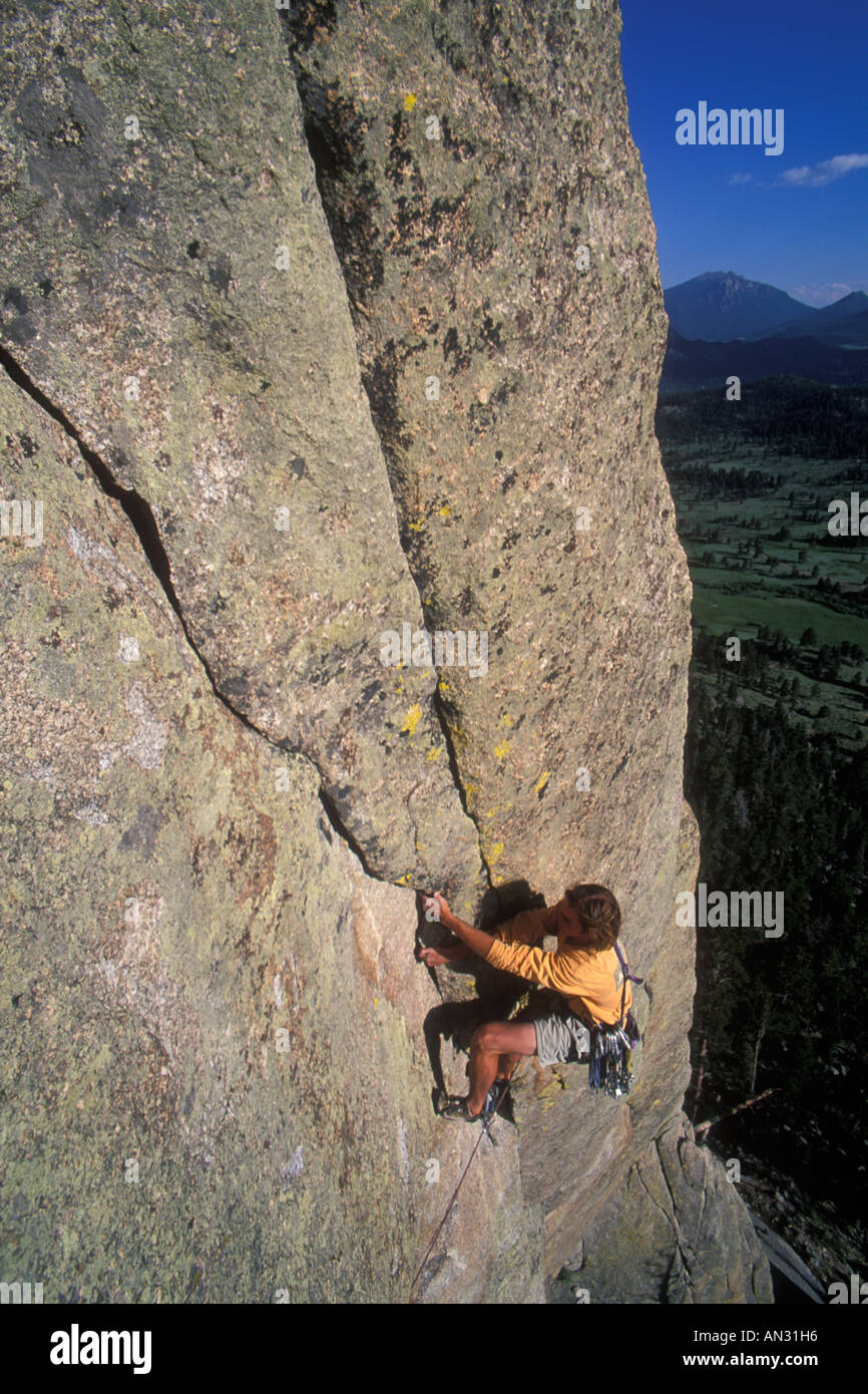 Rock climber ascending a steep rock face Stock Photo - Alamy