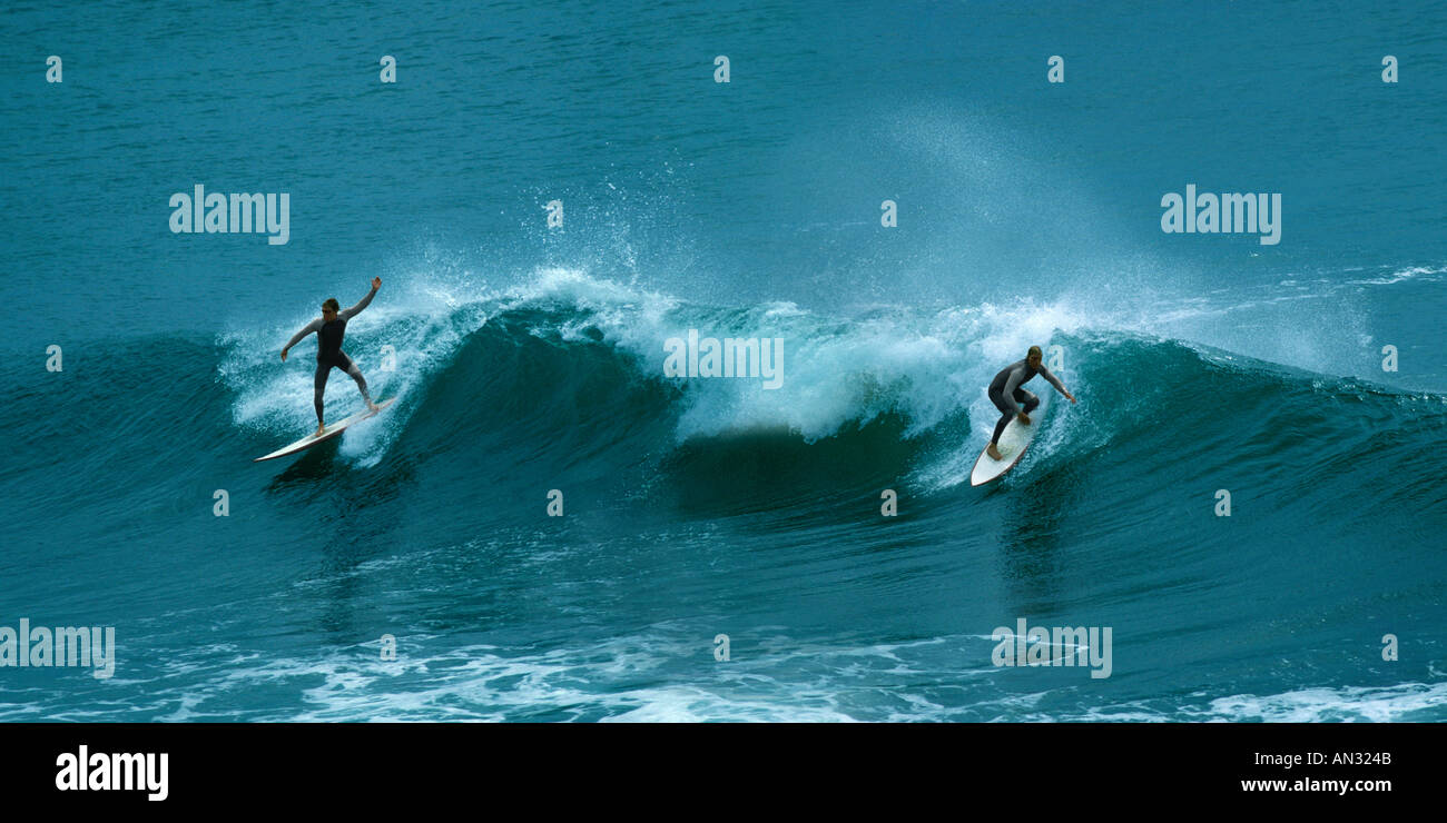 Two surfers riding wave concept Stock Photo - Alamy Two surfers riding wave concept Stock Photo - Alamy