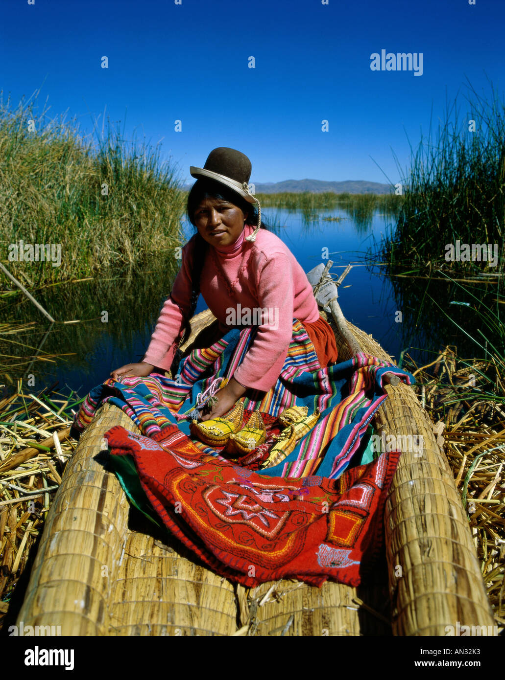 Uros indian woman in traditional reed boat hi-res stock photography and ...