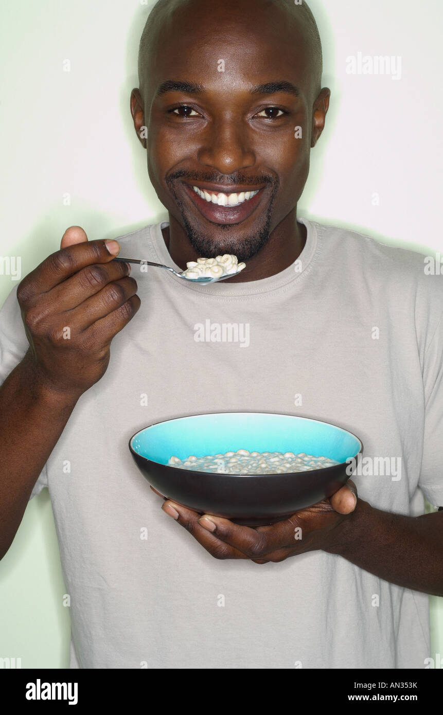Portrait of African man eating cereal Stock Photo - Alamy