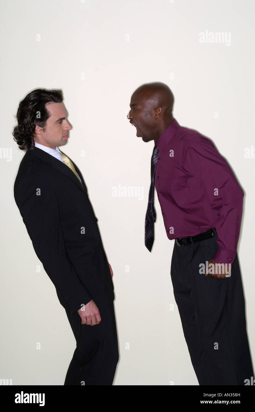 African businessman yelling at coworker Stock Photo - Alamy