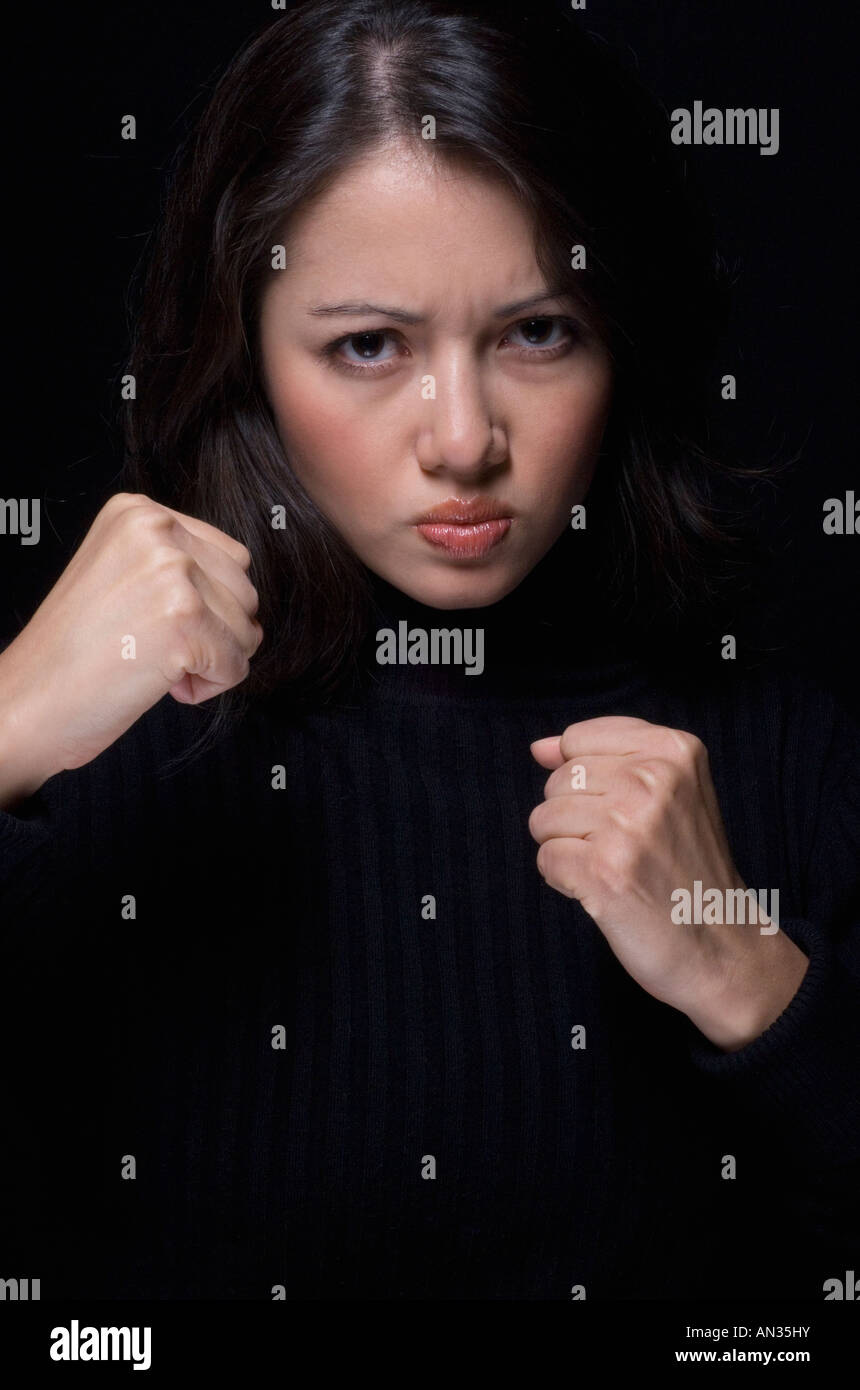 Portrait of Hispanic woman holding fists up Stock Photo - Alamy